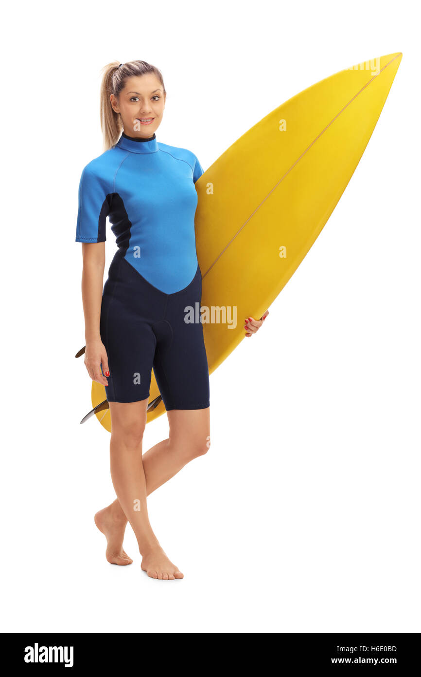 Full length portrait of a female surfer posing with a surfboard ...