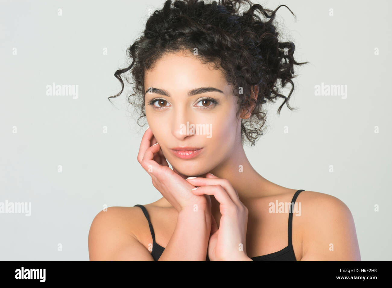Beautiful young woman hand touching face Stock Photo - Alamy