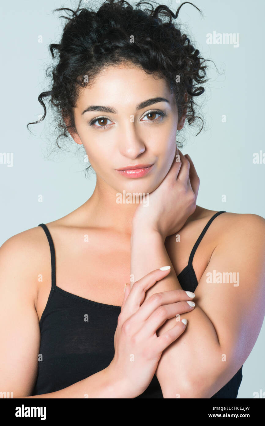 Beautiful young woman hand touching neck Stock Photo - Alamy