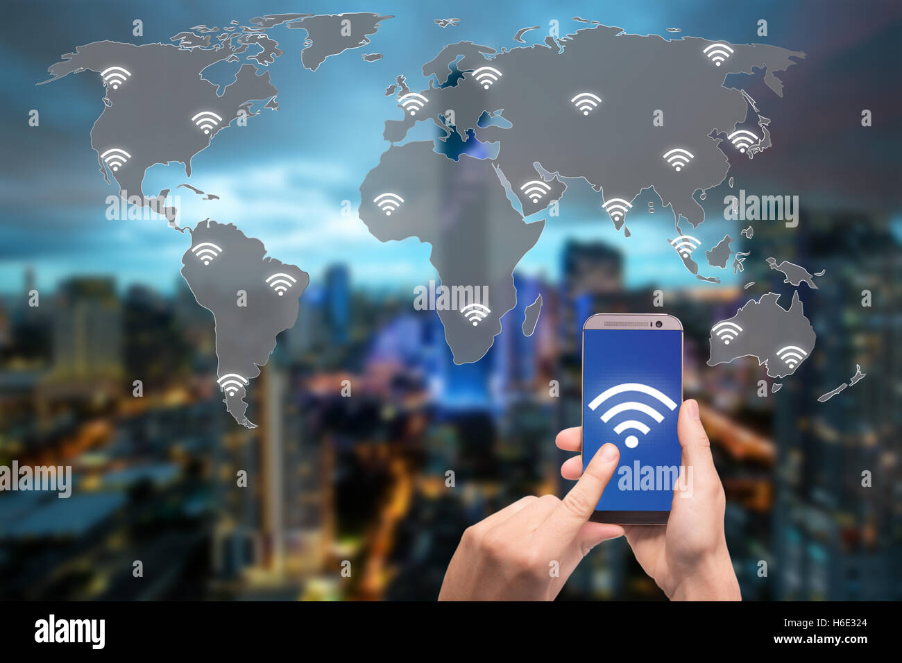 Hand holding mobile phone with wifi icon on world map and city and ... Hand holding mobile phone with wifi icon on world map and city and ...
