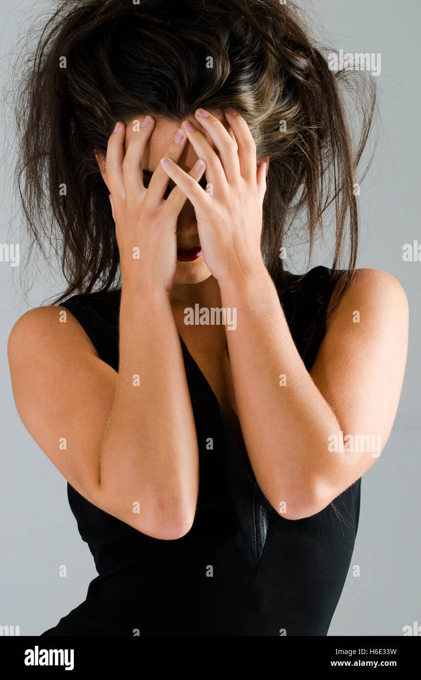 Woman hiding face with hands Stock Photo - Alamy
