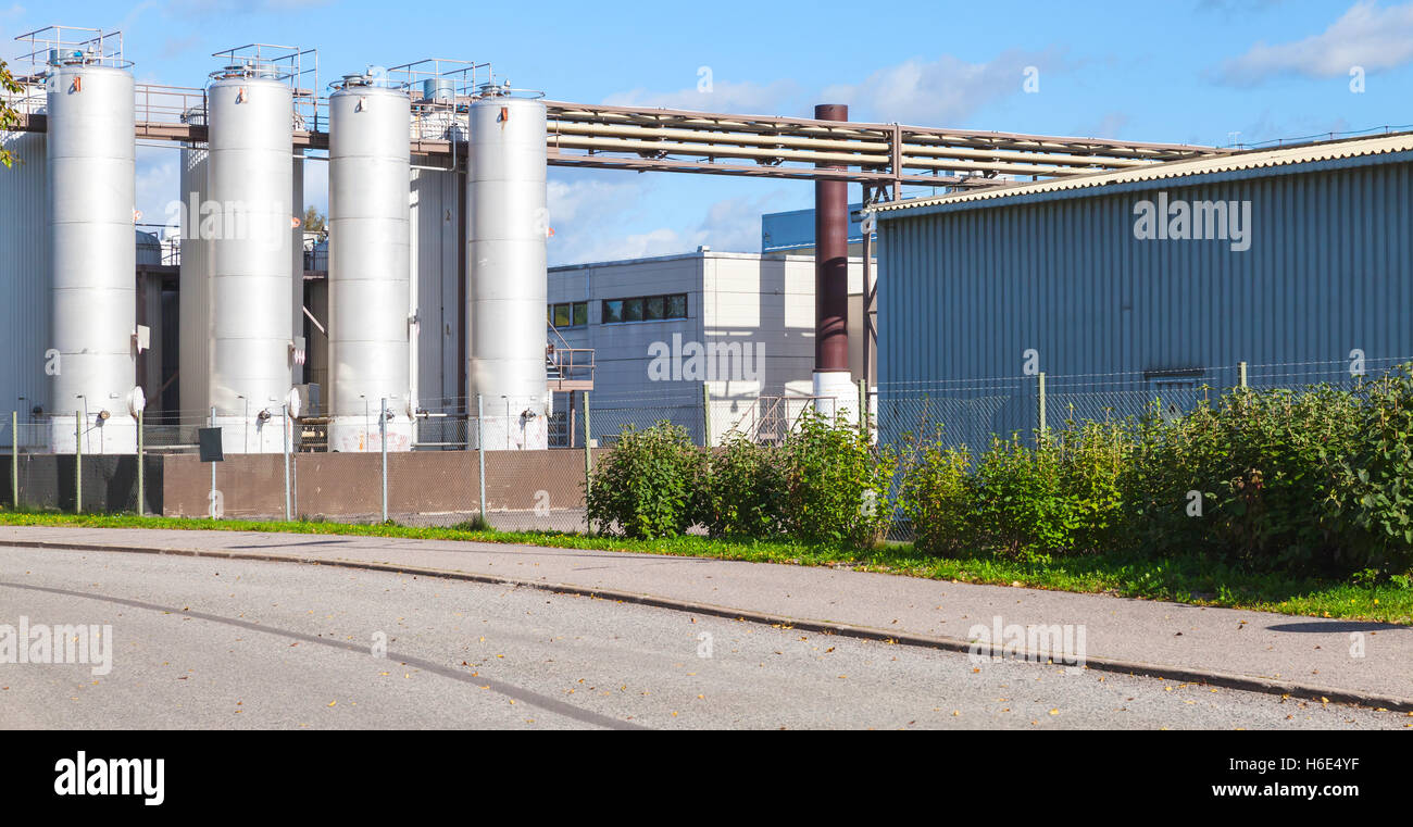 Modern street view with factory buildings and tanks in summer day Stock ...
