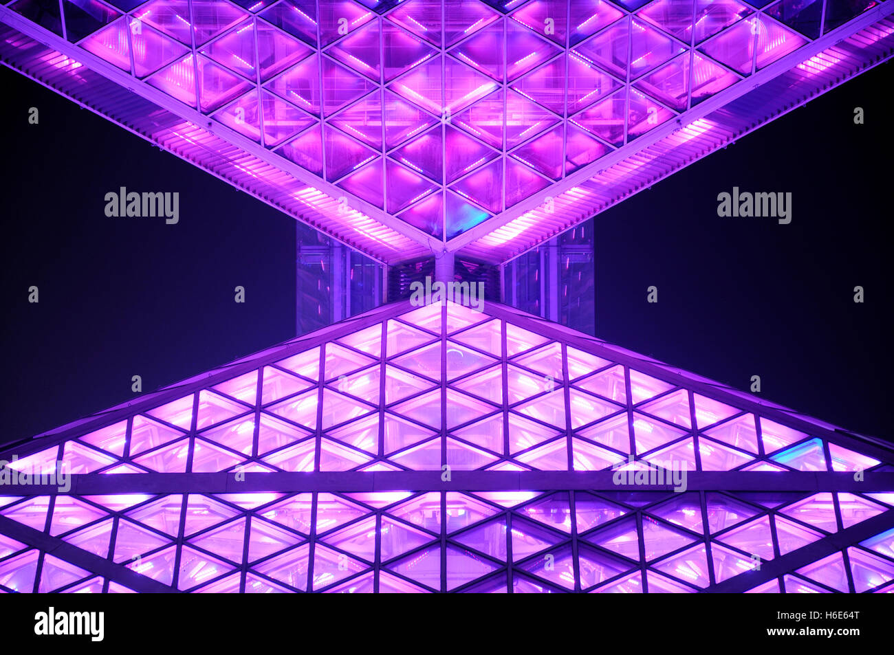 Abstract architecture light up at night with pinkish and purple ...