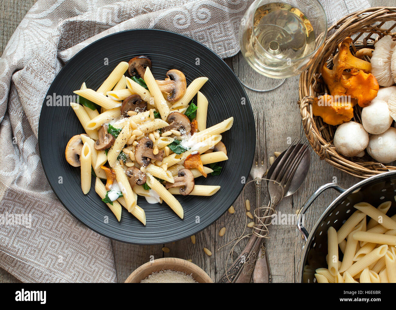 Pasta with mushrooms on rustic tabletop Stock Photo - Alamy