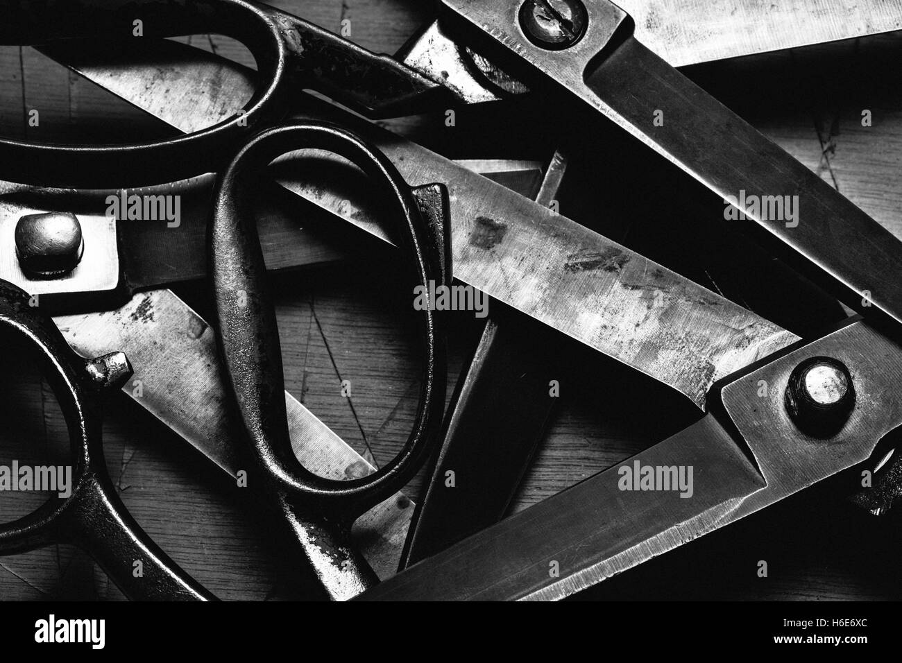 Scissors overlapping across a grunge surface Stock Photo - Alamy