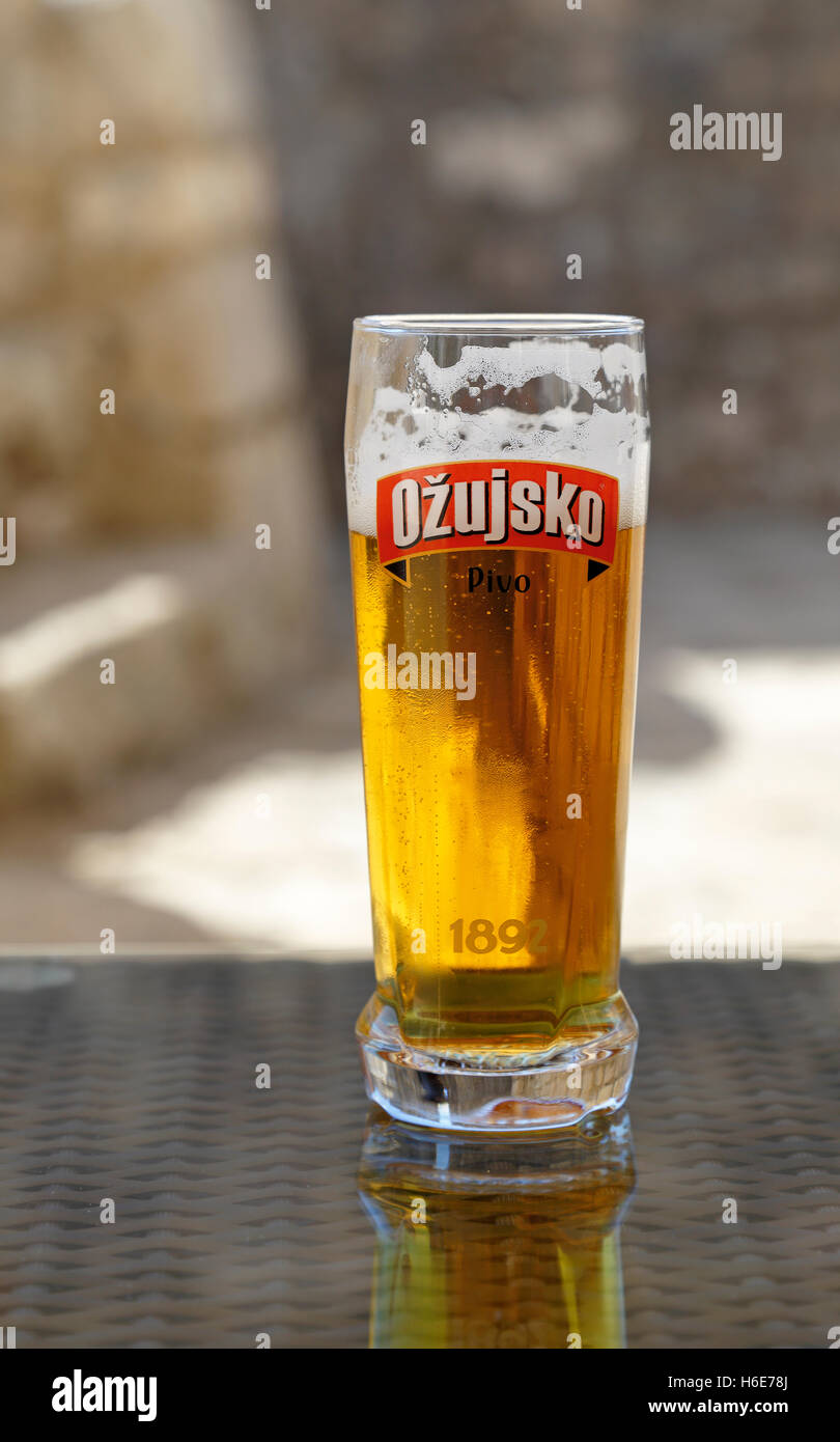 Glass of Ozujsko beer on a table in Hvar, Croatia, Dalmatia, Dalmatian ...