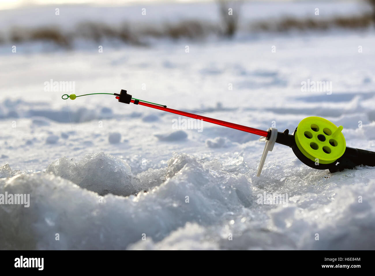 Little winter fishing rod ice Stock Photo - Alamy