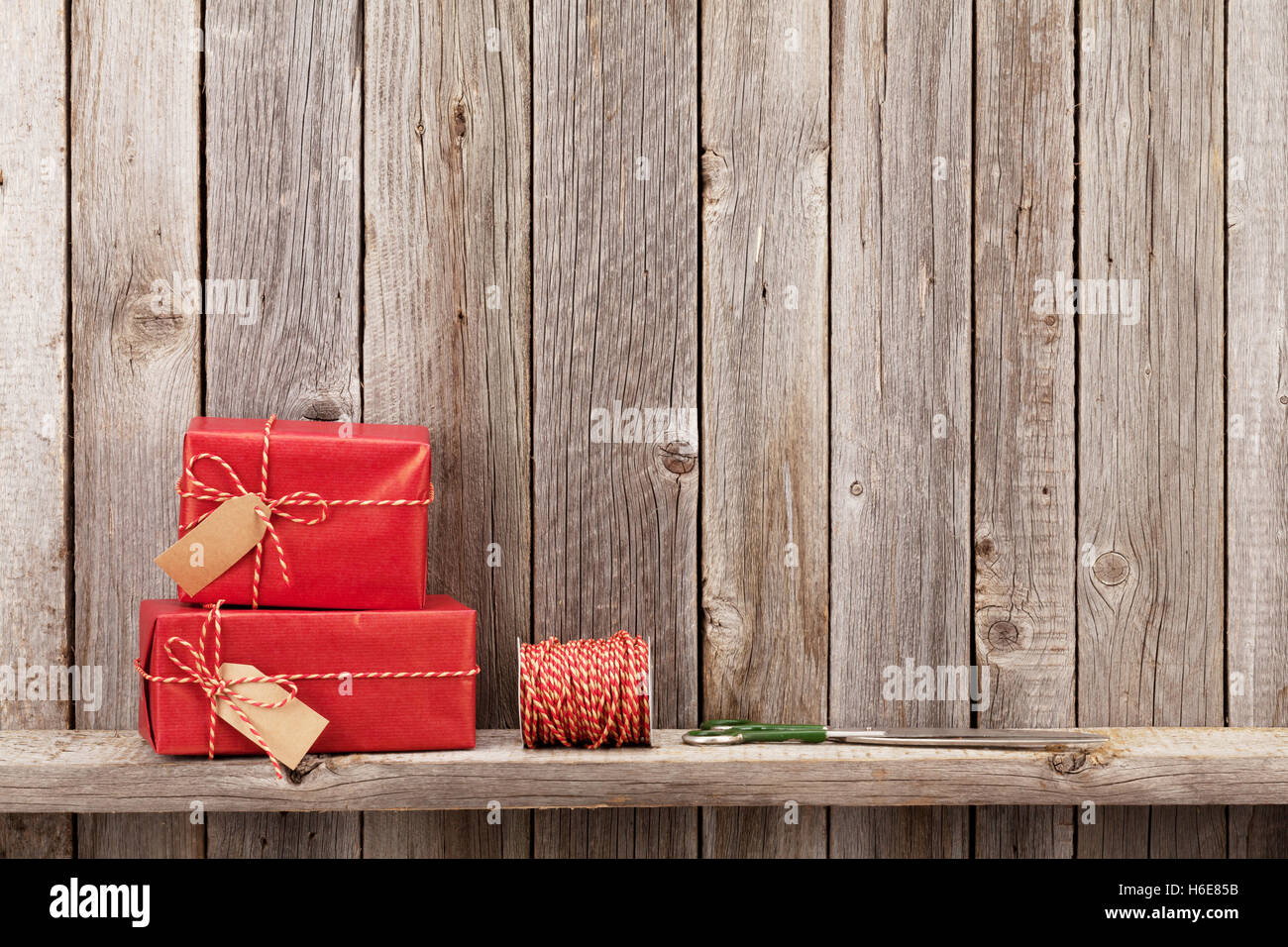 Christmas gift boxes in front of wooden wall with copy space Stock ...
