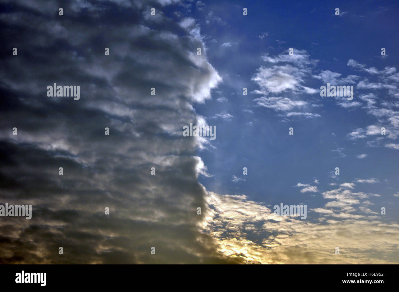 Clouds divided sky during sunset colorful light against dark Stock ...
