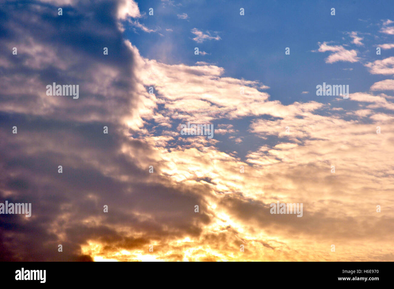 Clouds divided sky during sunset colorful light against dark 4 Stock ...