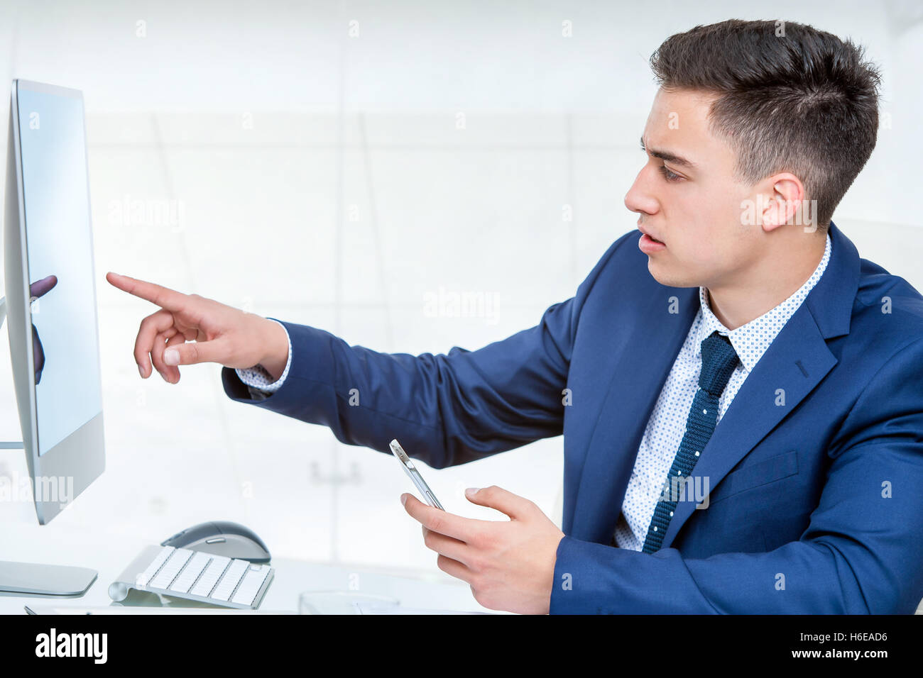 Close up portrait of Young businessman comparing information on ...