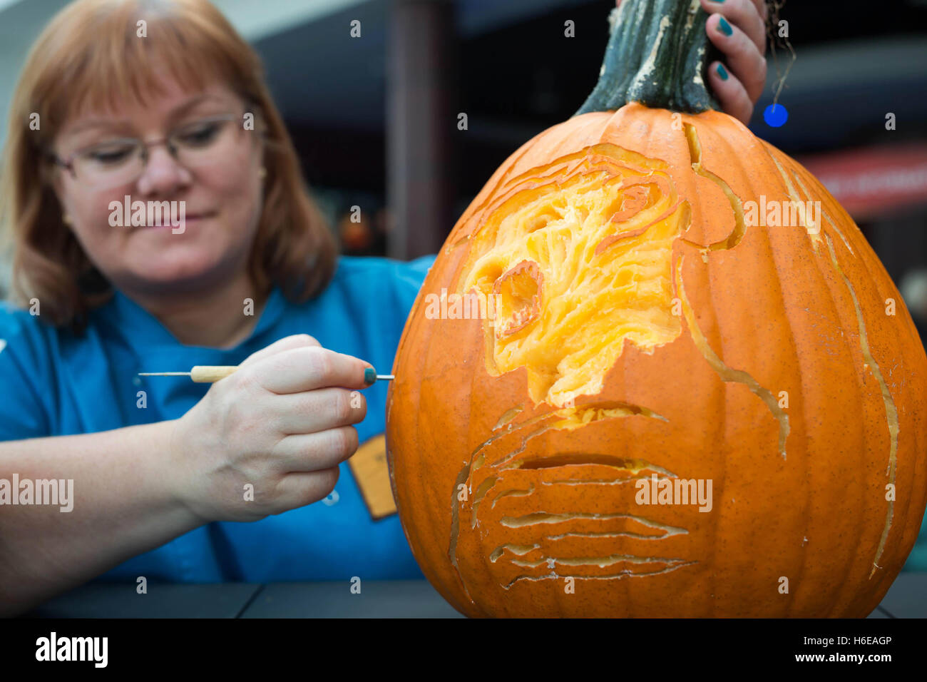 EDITORIAL USE ONLY Artist Jacqui Kelly carves a pumpkin to resemble the ...