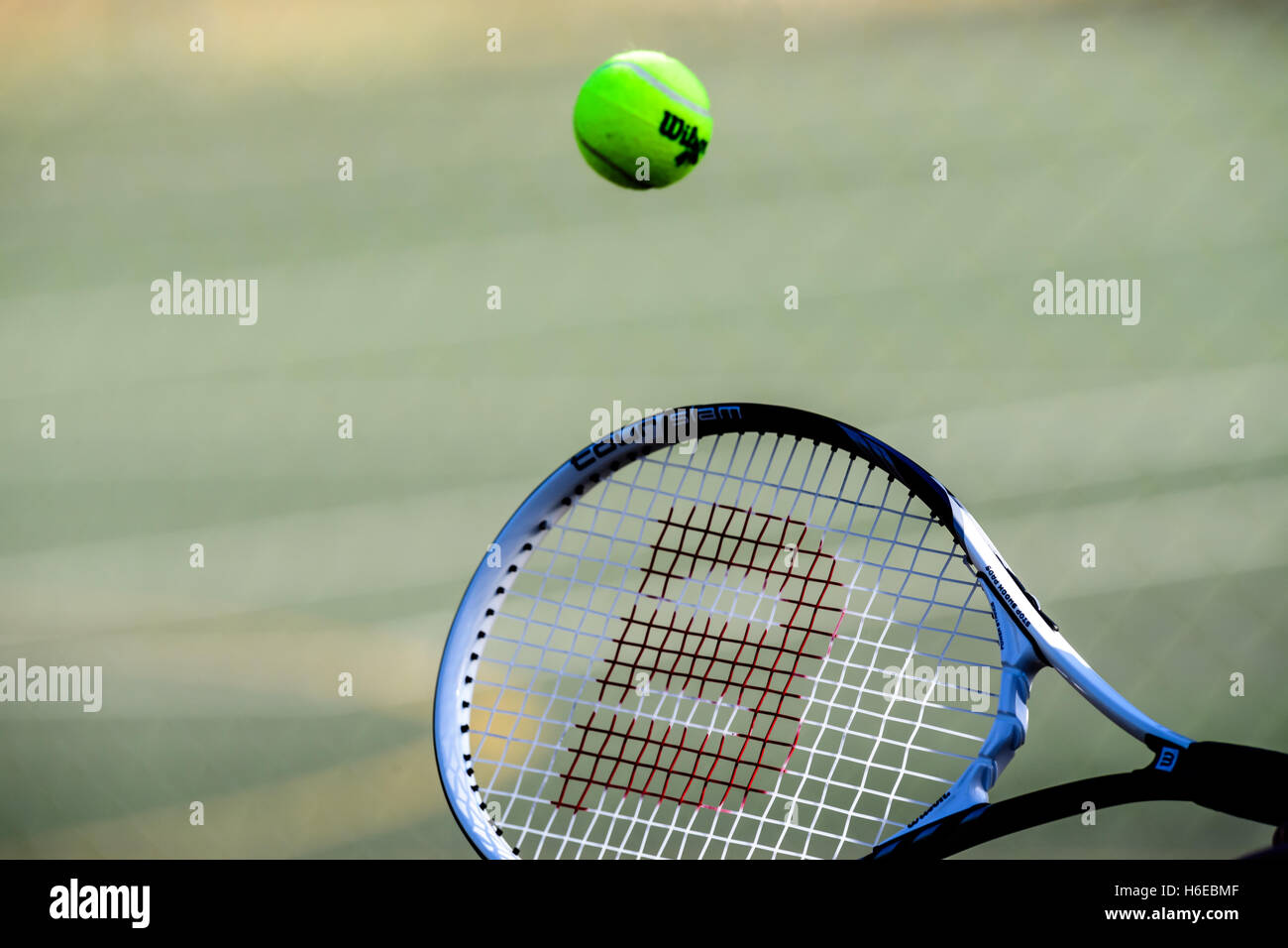 Tennis ball hitting a racket Stock Photo - Alamy