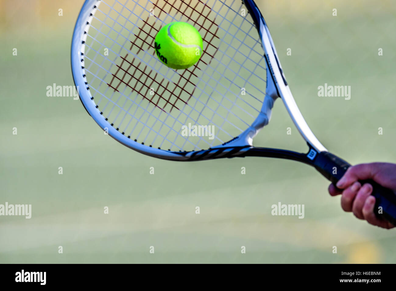 Tennis ball hitting a racket Stock Photo - Alamy