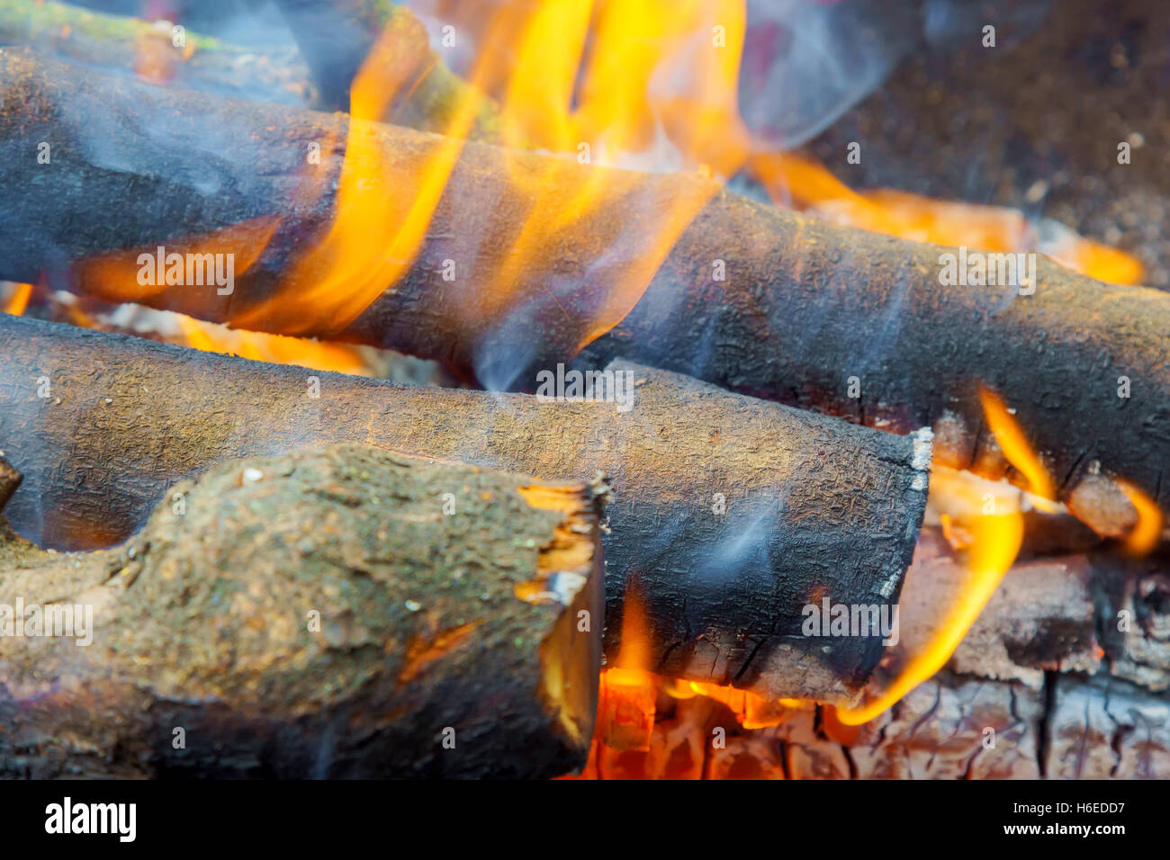 Burning in the fire board. Bonfire with flame, smoke, wooden planks and ...