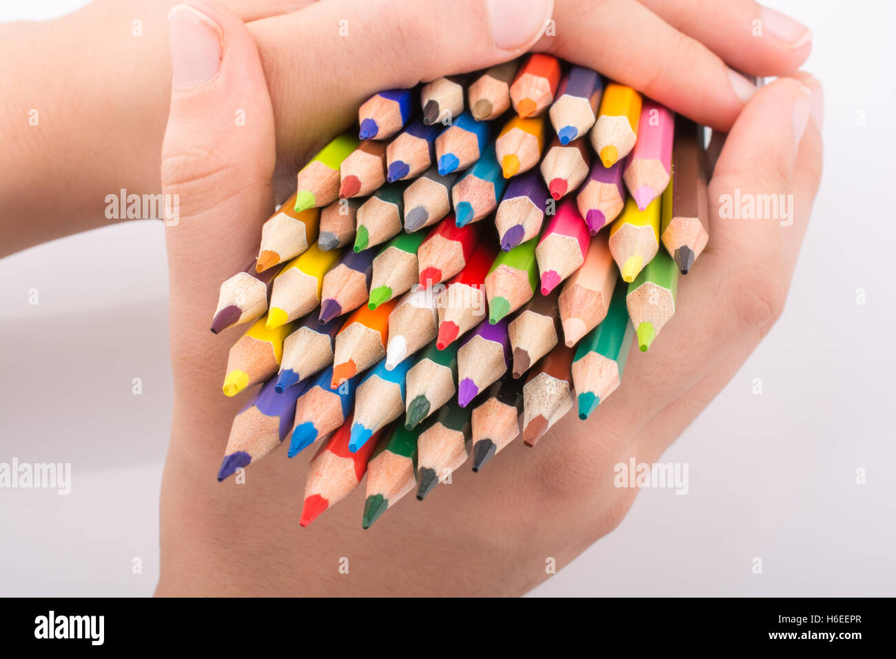 Hand holding Color Pencils on a white background Stock Photo - Alamy