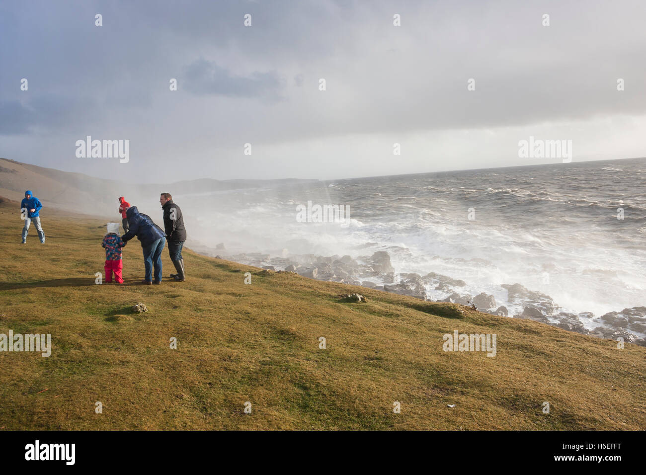 wild storm sea crashing ashore near people walking young child Stock ...