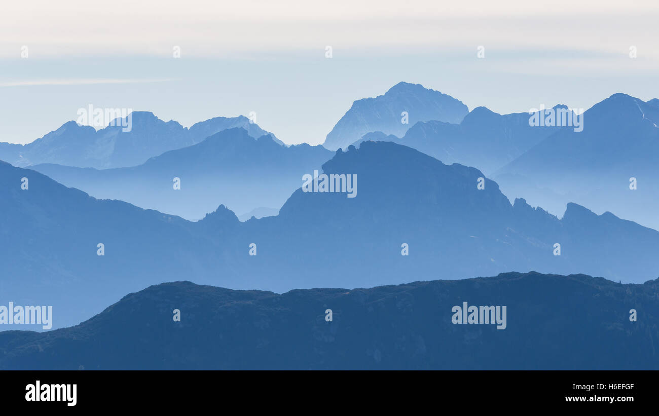 During a blue dawn in the Austrian Alps, only the silhouettes of the ...