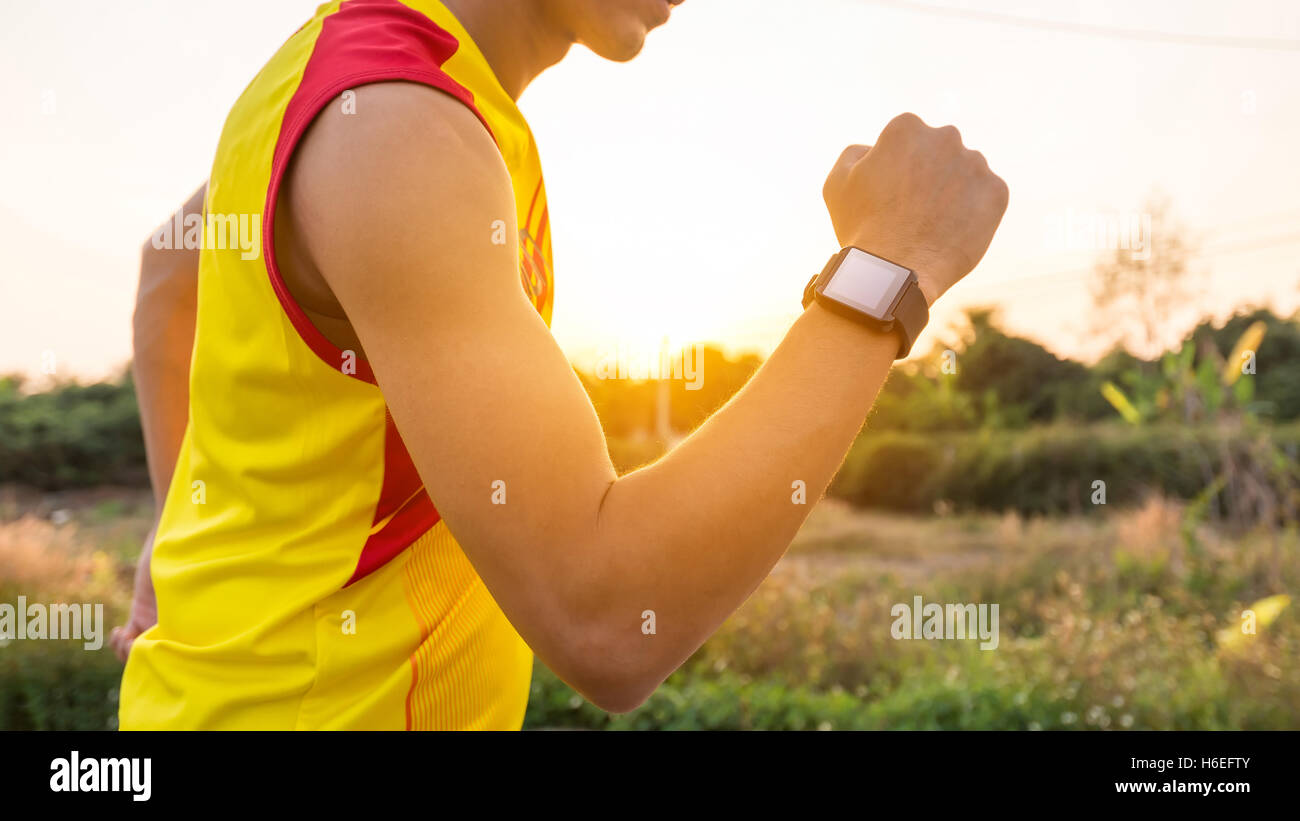 Photo of a man running with smart watch Stock Photo - Alamy