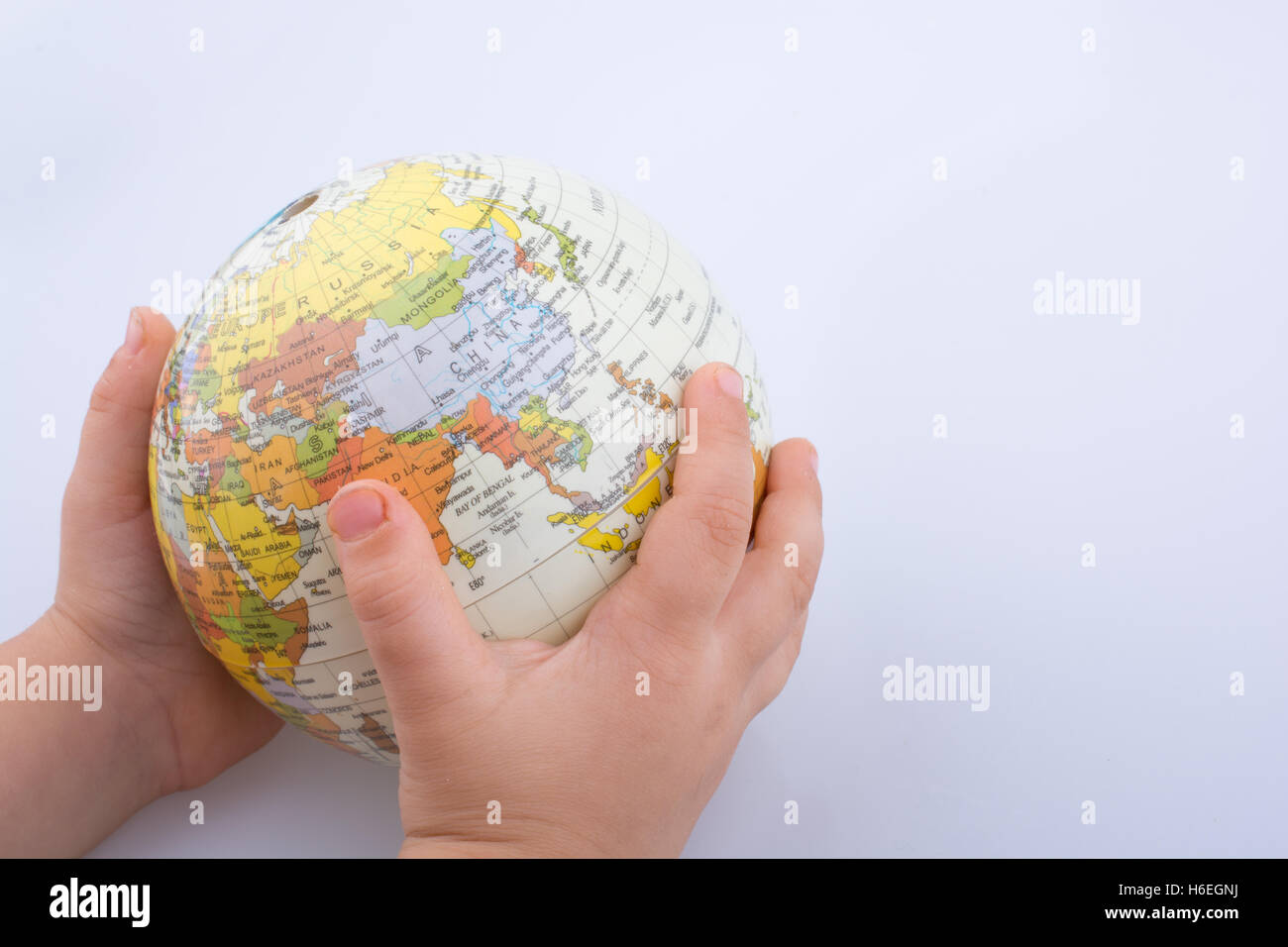 Child holding a globe in his hand on a white background Stock Photo - Alamy