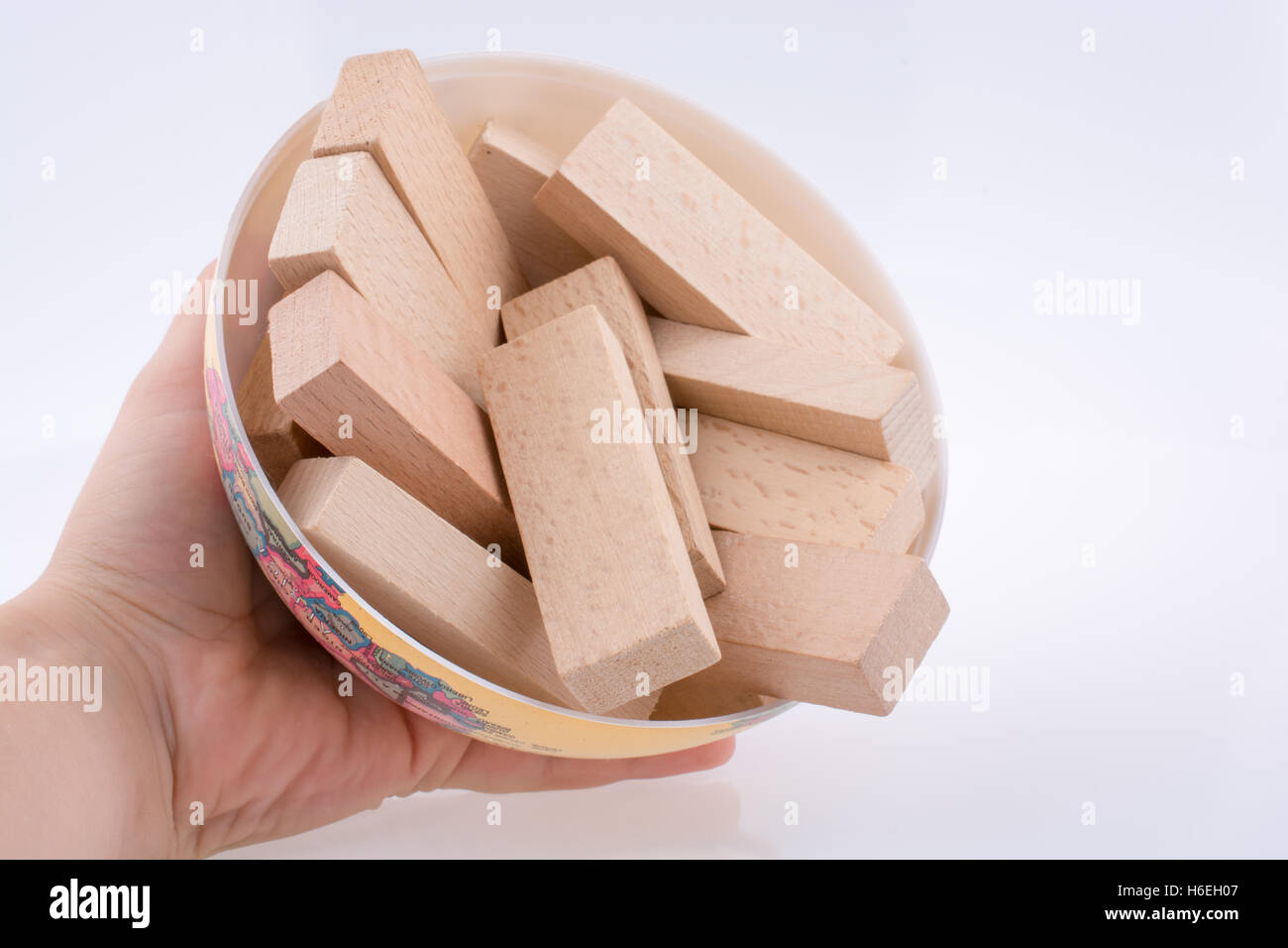 Hand playing with wooden building blocks on white background Stock ...