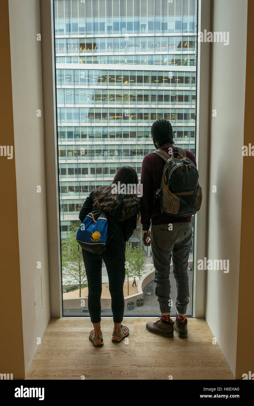 two people looking out of Tate modern extension floor to ceiling window ...