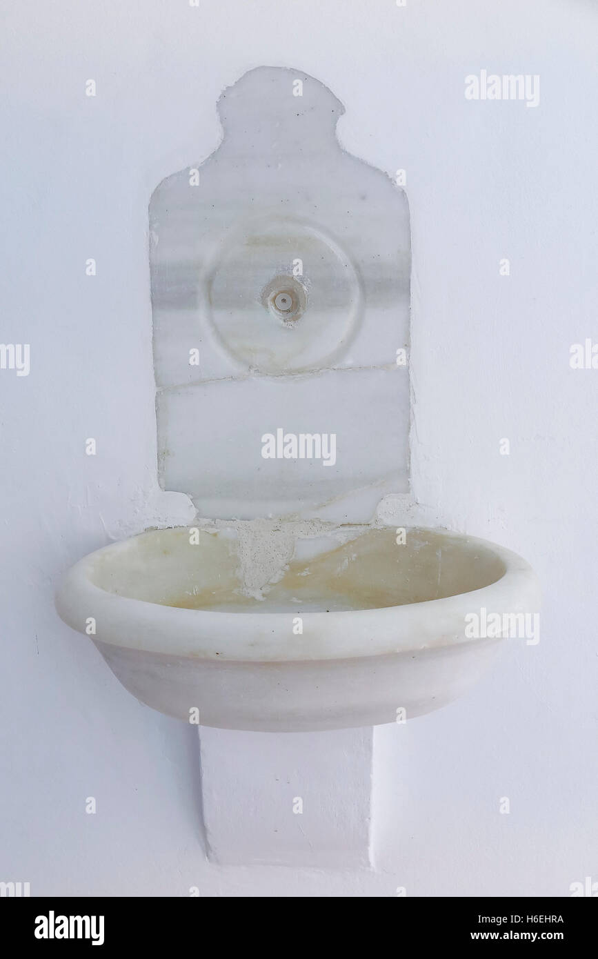 antique stoup placed on a white wall Stock Photo - Alamy