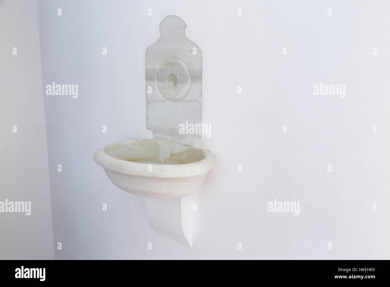 antique stoup placed on a white wall Stock Photo - Alamy