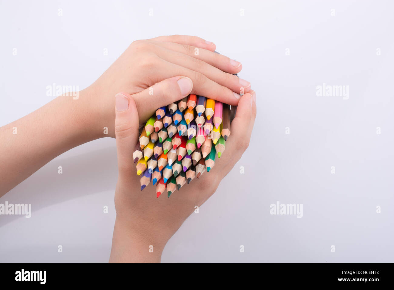 Hand holding Color Pencils on a white background Stock Photo - Alamy