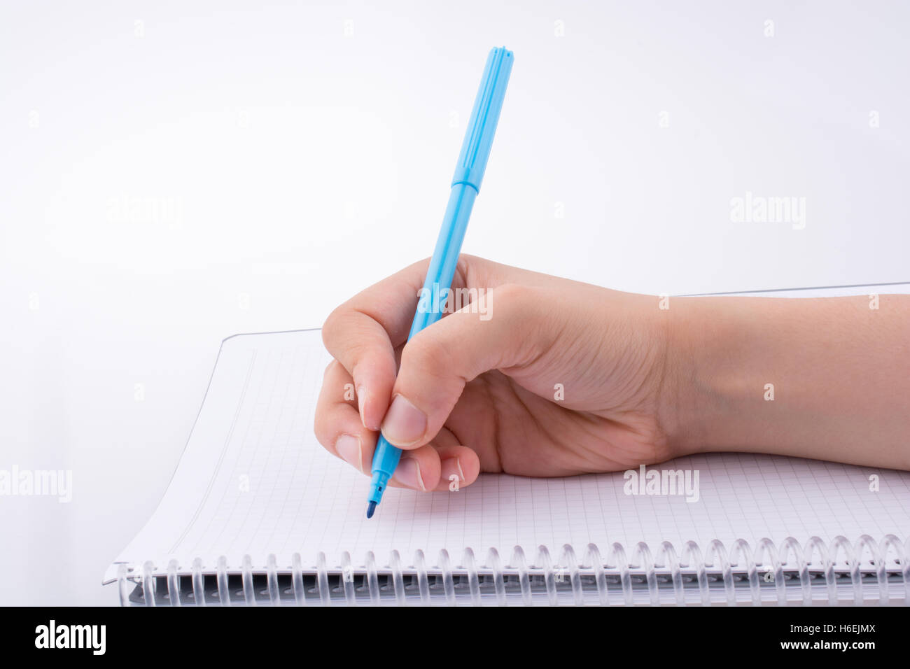 Hand writing on a Notebook with a pen on a white background Stock Photo ...