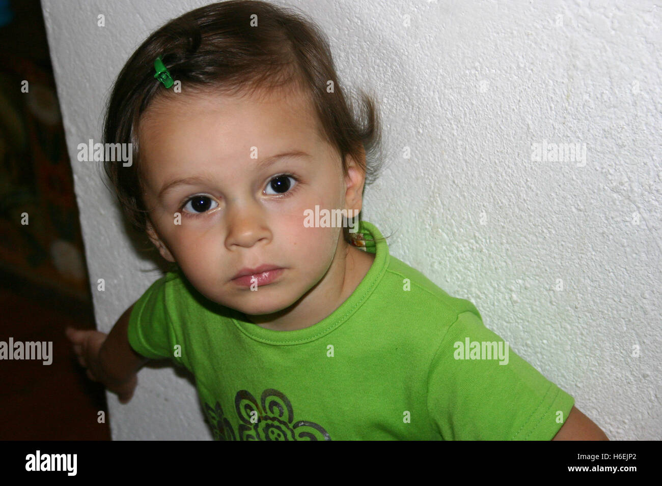 Little toddler girl with serious expression Stock Photo - Alamy