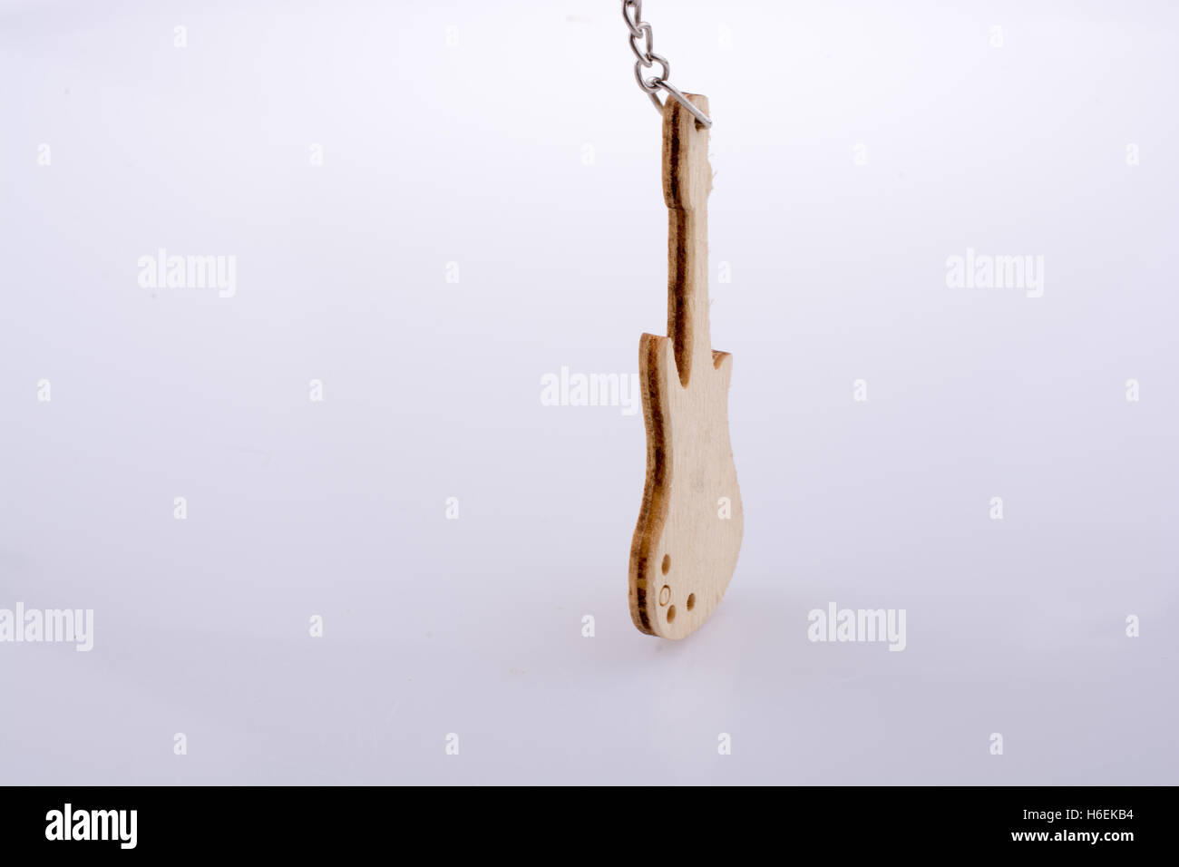 Mini wooden guitar model on a white background Stock Photo - Alamy