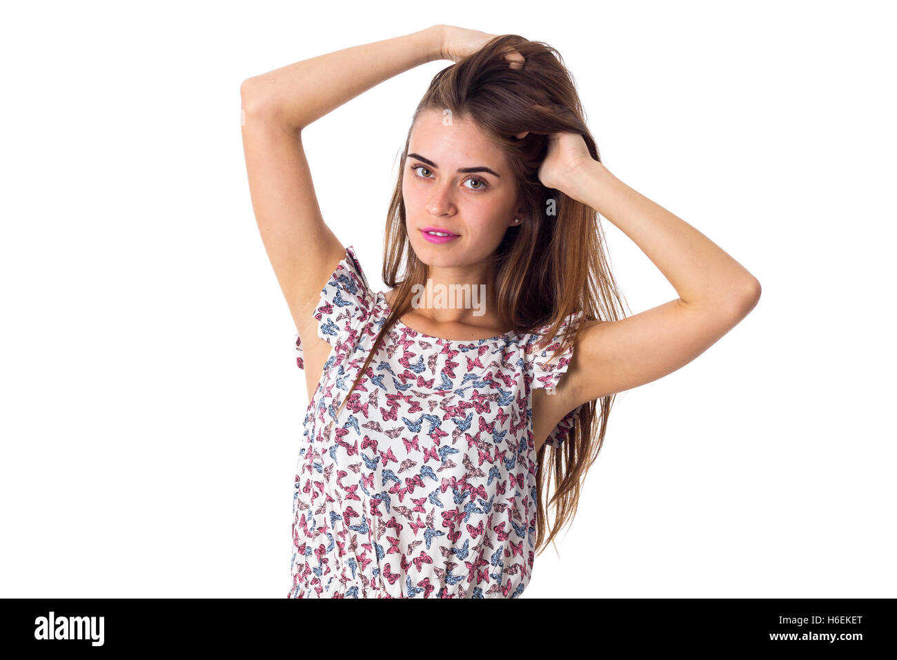 Young woman in dress fixing hair Stock Photo - Alamy
