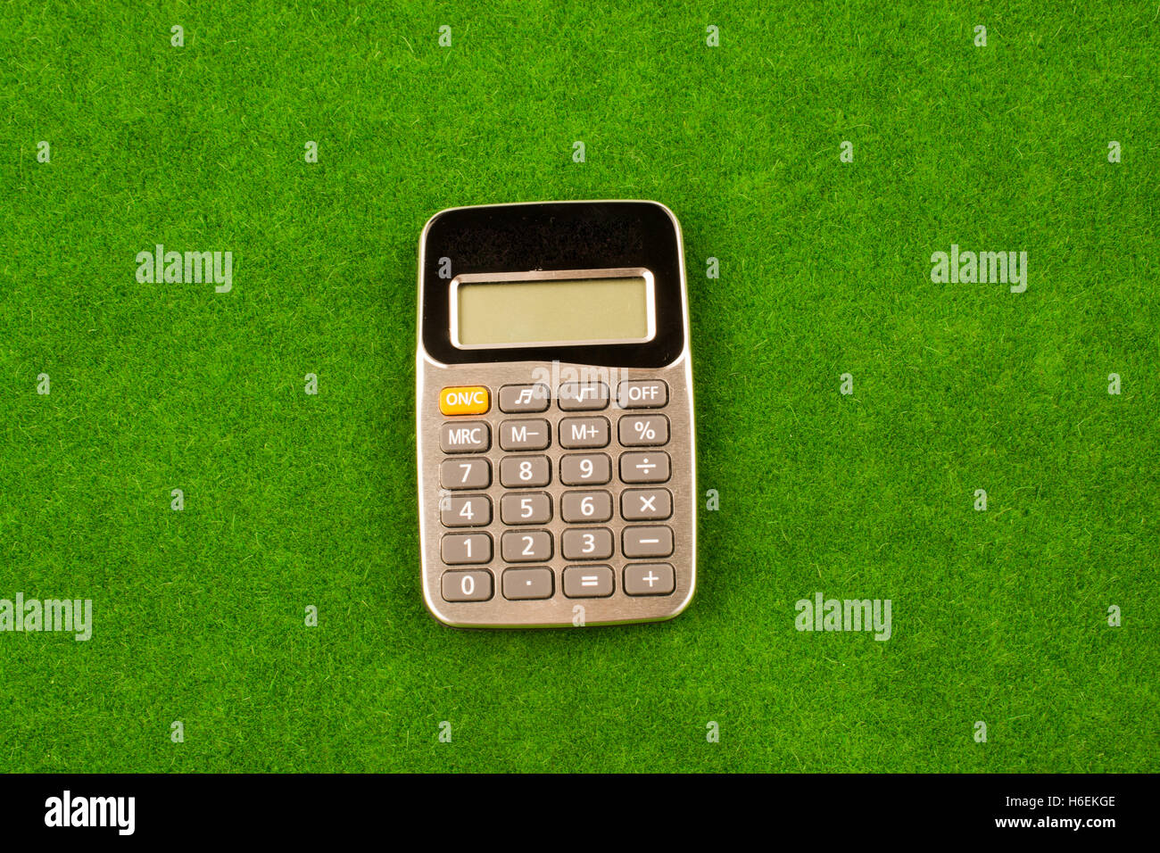Calculator placed in green grass Stock Photo - Alamy