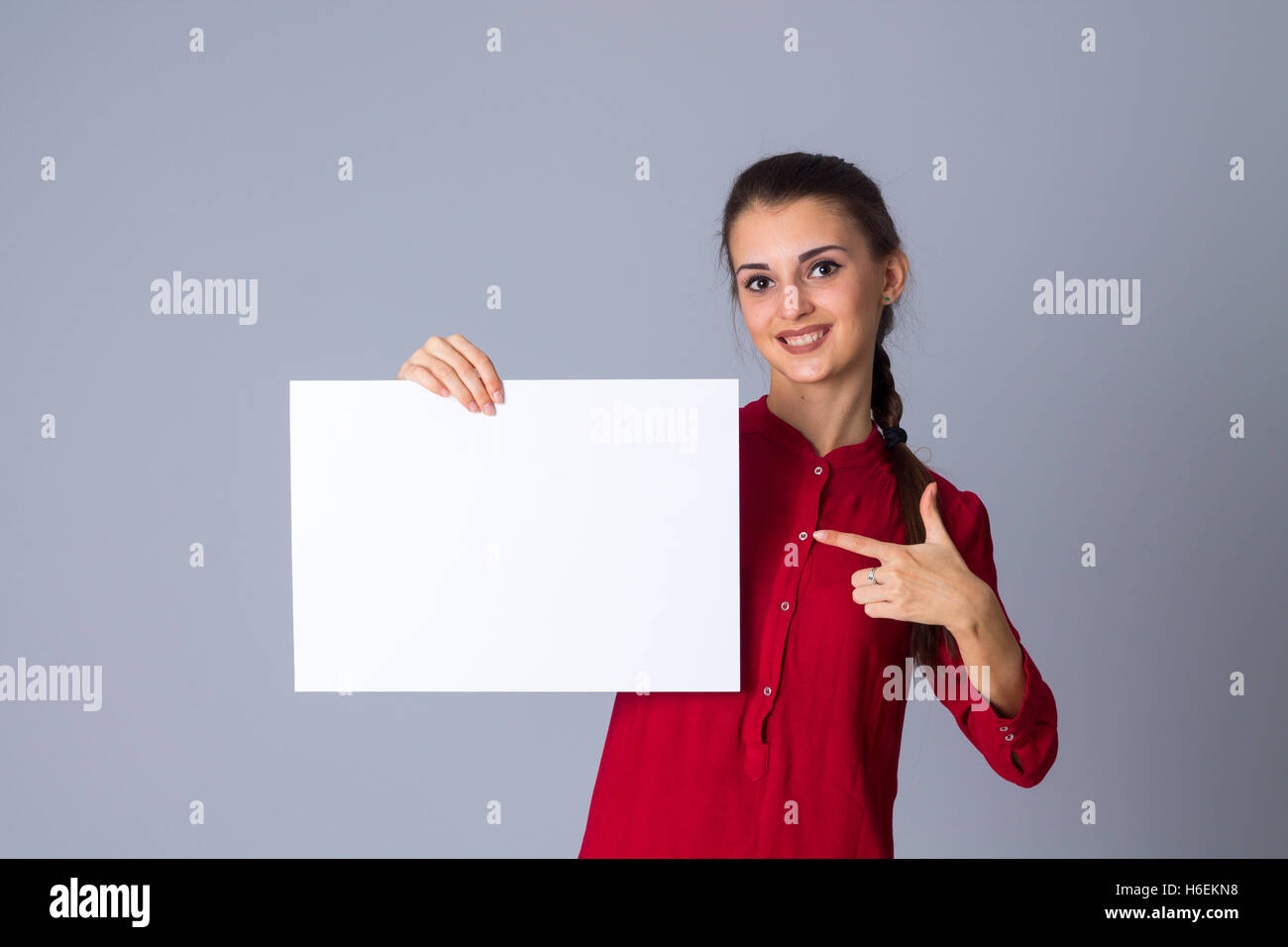Woman holding white sheet of paper Stock Photo - Alamy