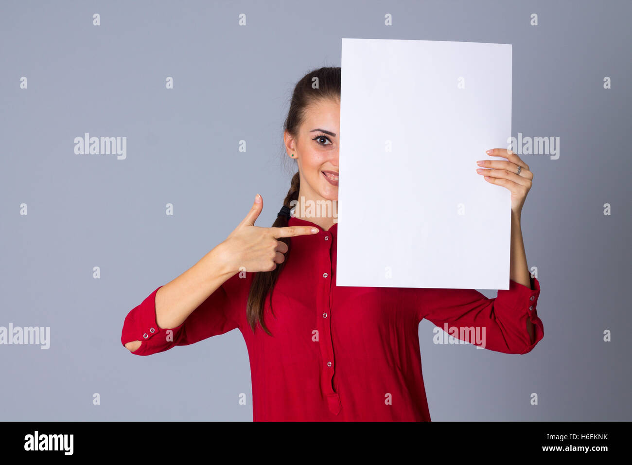 Woman holding white sheet of paper Stock Photo - Alamy