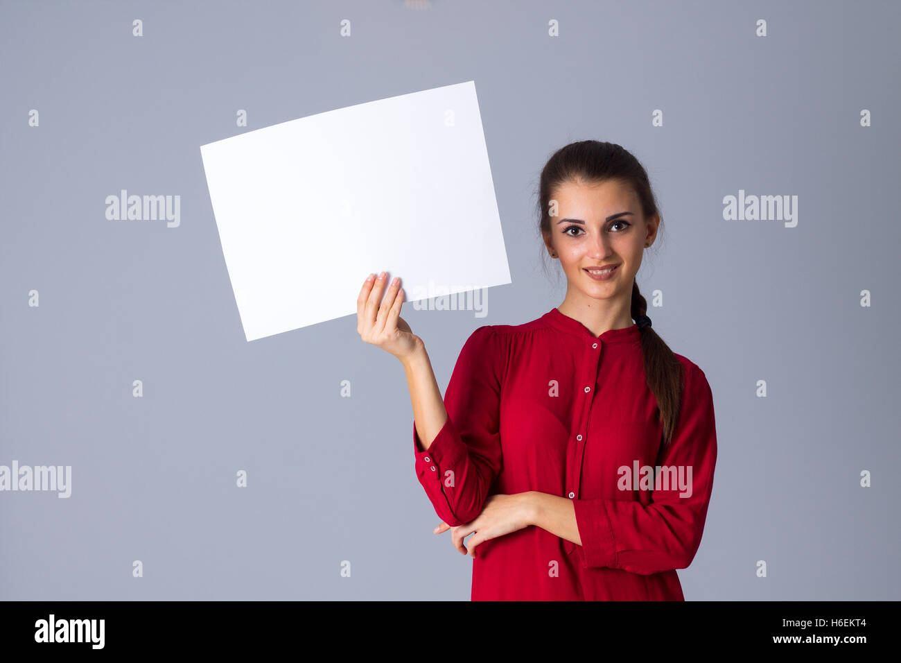 Woman holding white sheet of paper Stock Photo - Alamy