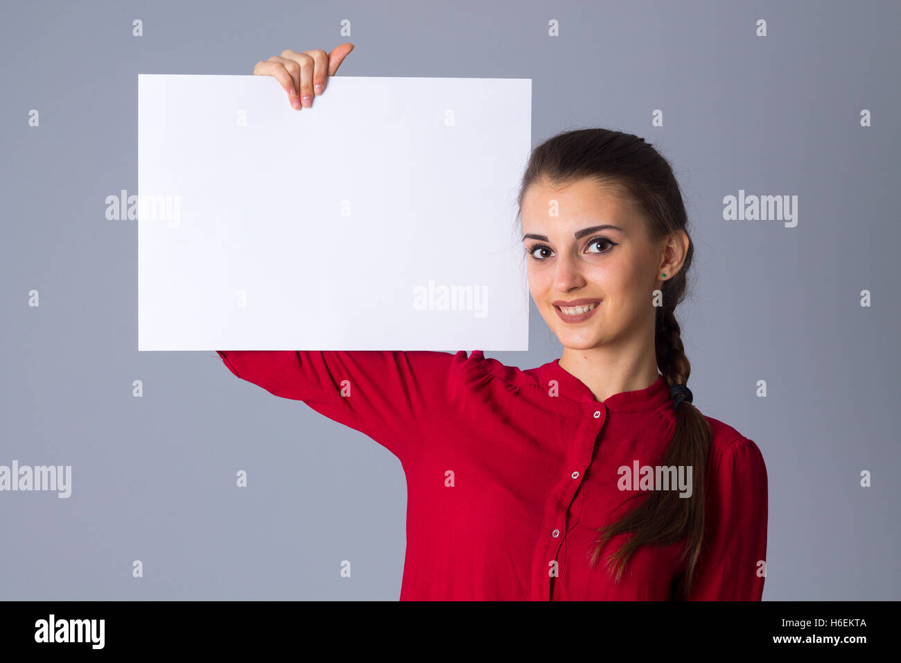 Woman holding white sheet of paper Stock Photo - Alamy