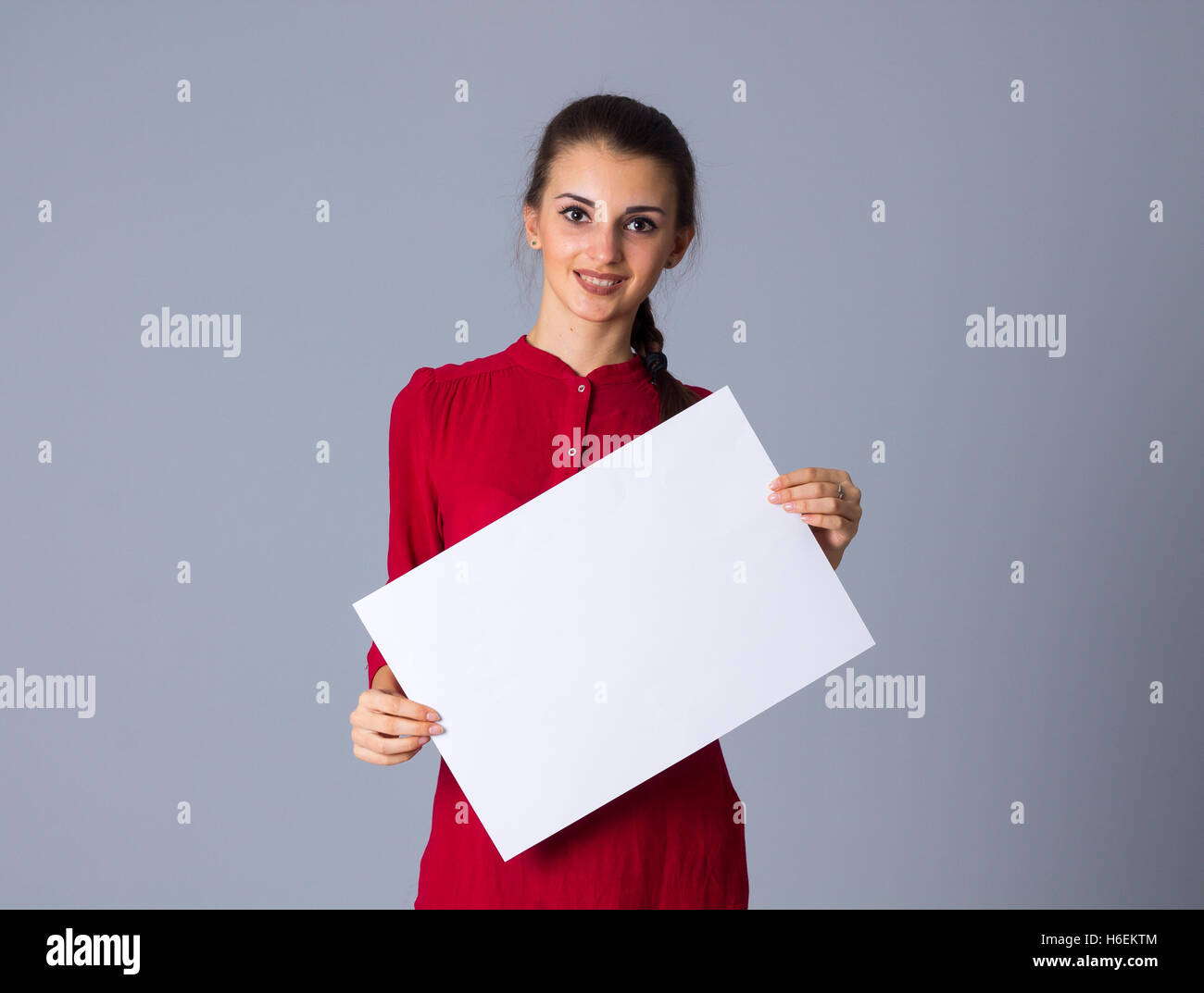Woman holding white sheet of paper Stock Photo - Alamy