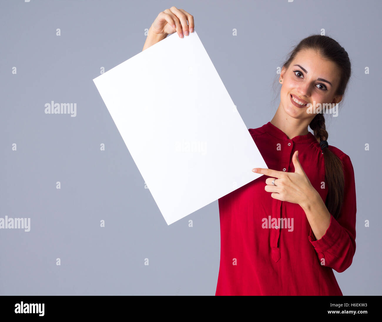 Woman holding white sheet of paper Stock Photo - Alamy
