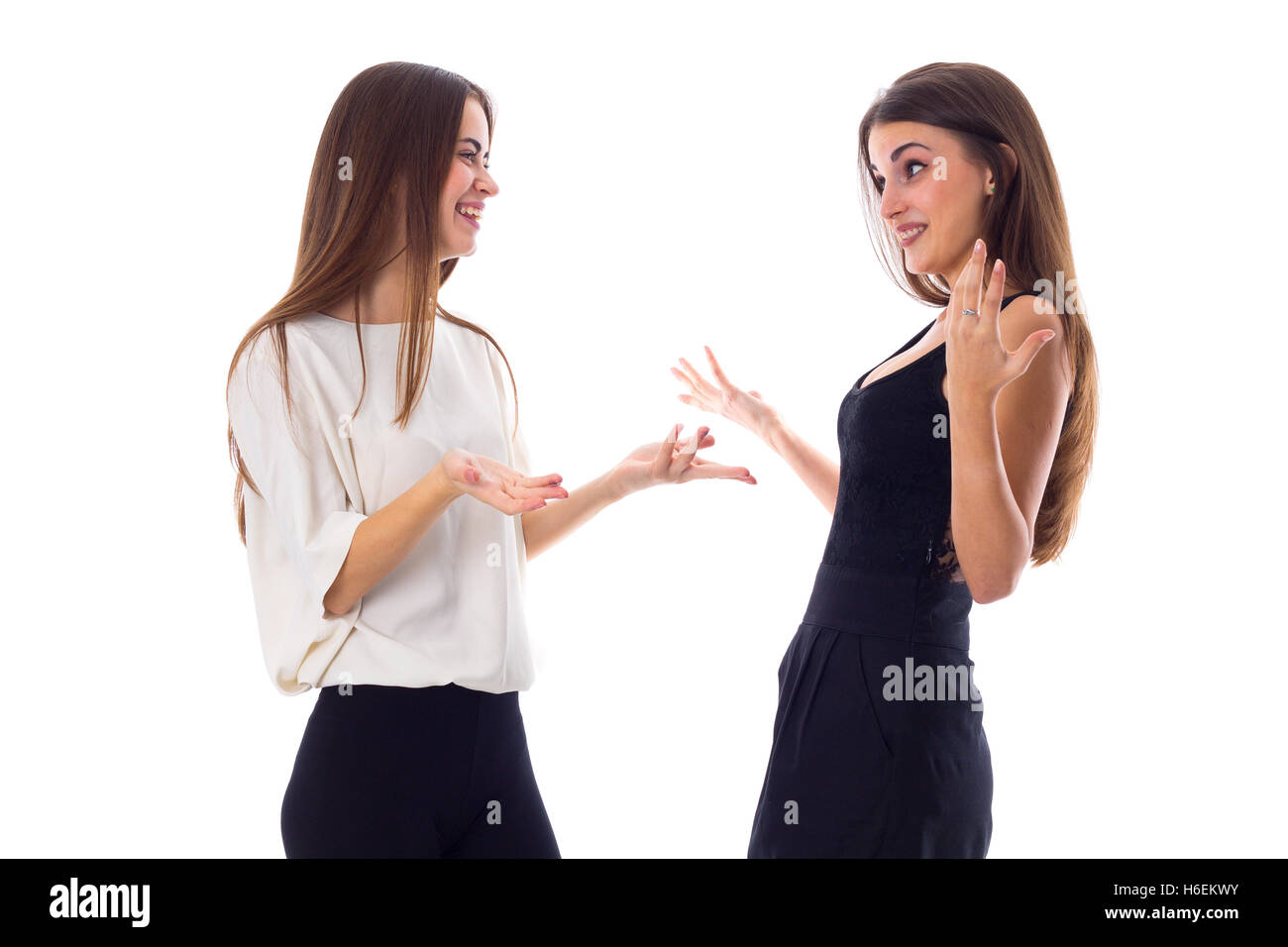 Two young woman talking Stock Photo - Alamy