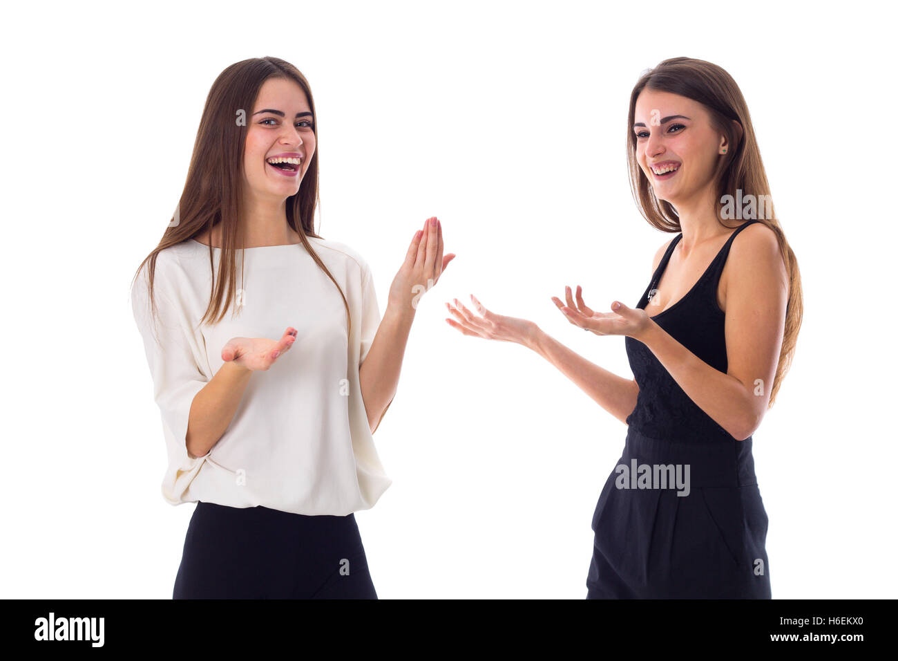 Two young woman talking Stock Photo - Alamy