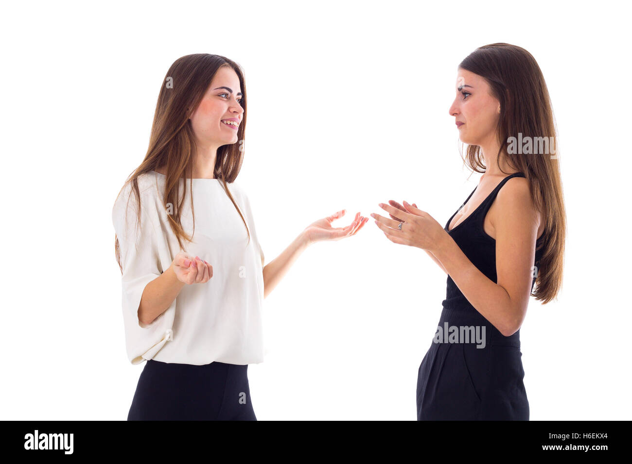 Two young woman talking Stock Photo - Alamy