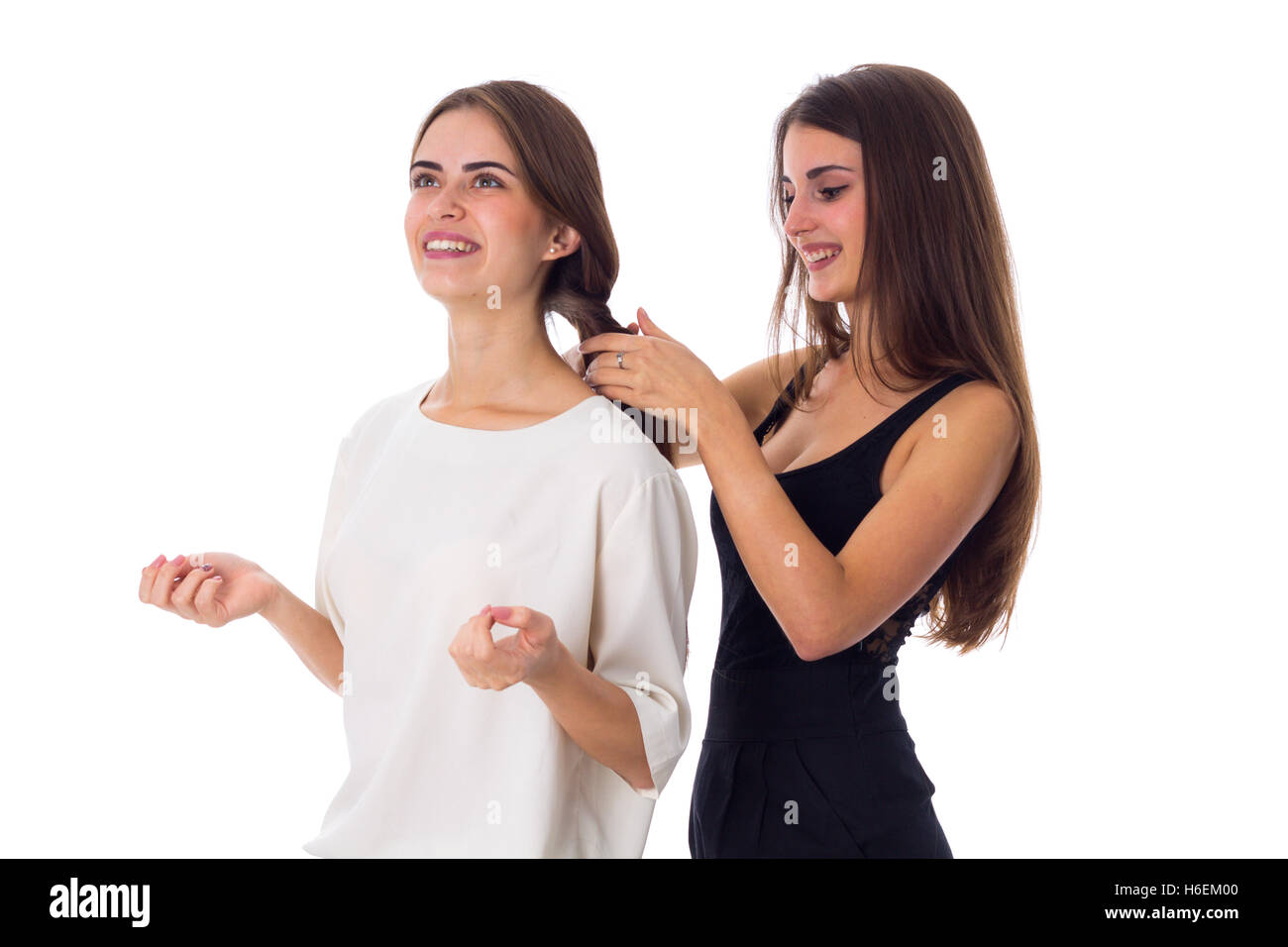 One woman making another one a plait Stock Photo - Alamy