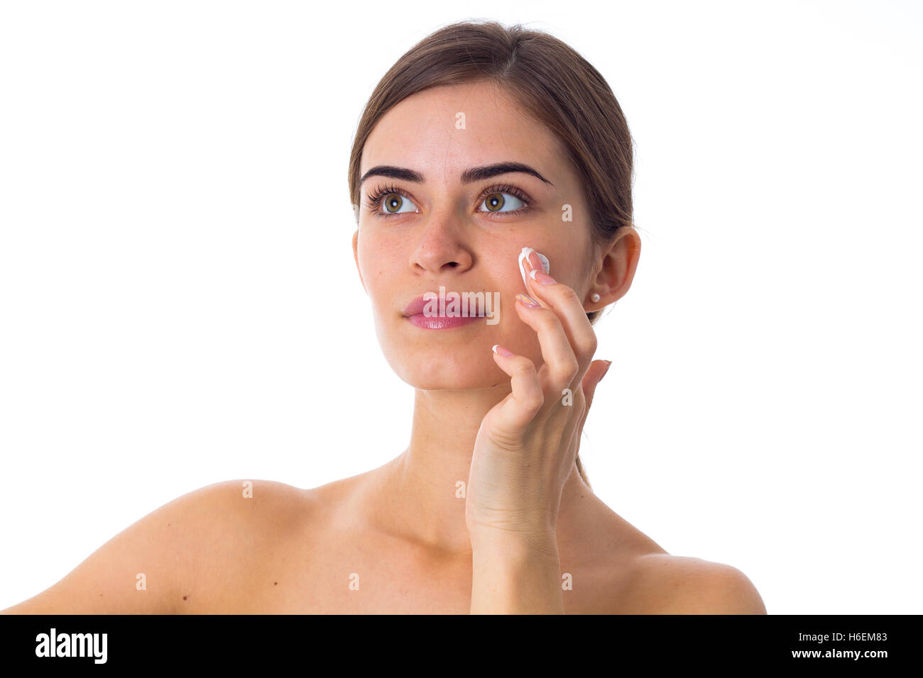 Young woman using cream Stock Photo - Alamy