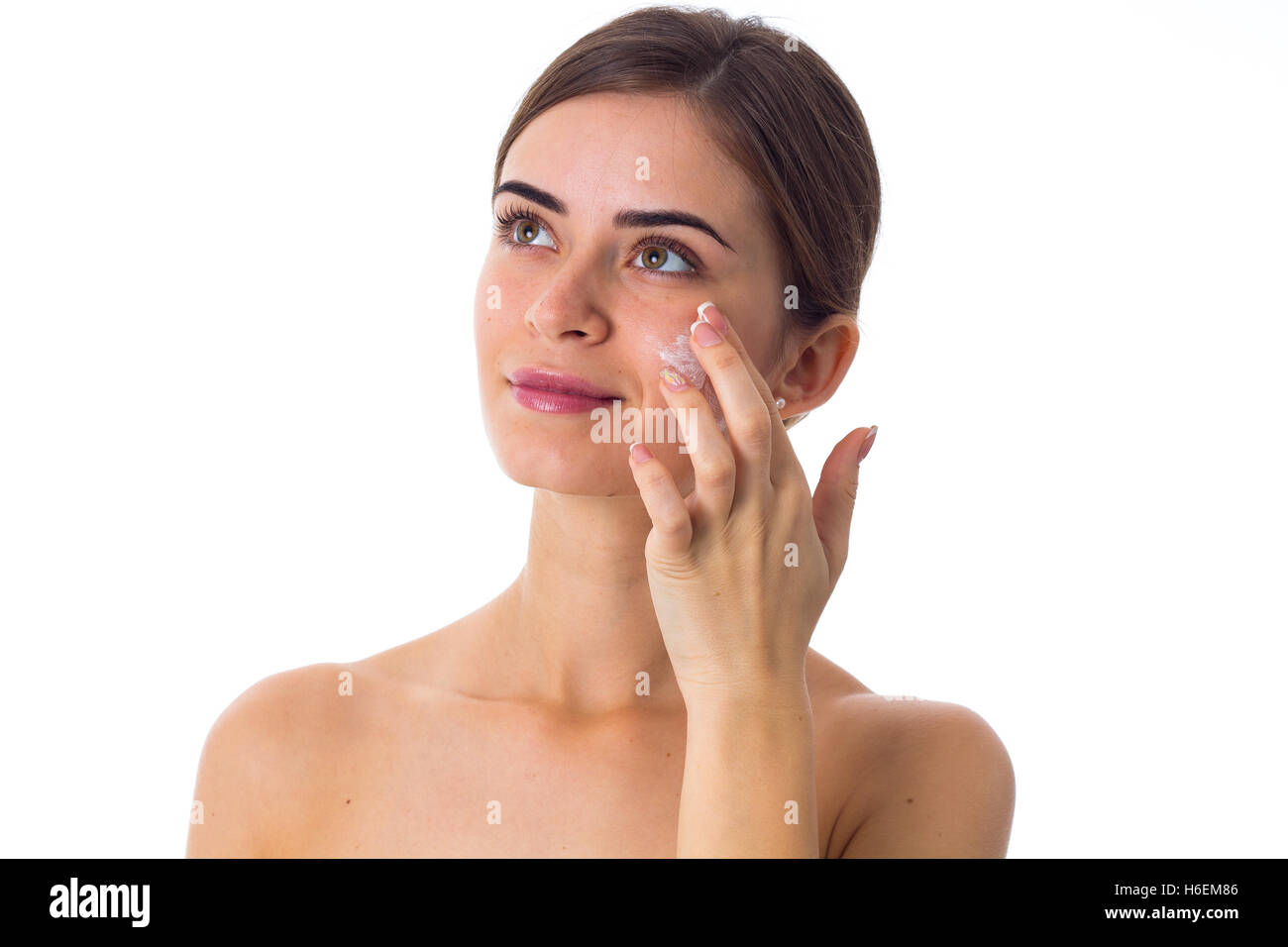 Young woman using cream Stock Photo - Alamy