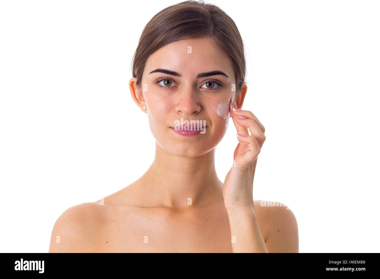 Young woman using cream Stock Photo - Alamy
