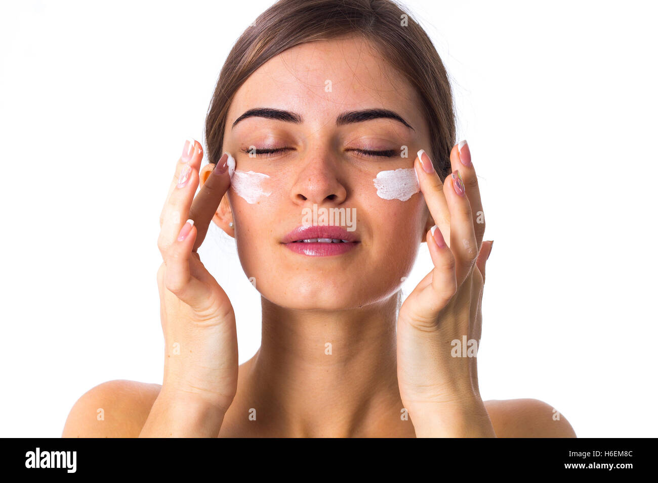 Young woman using cream Stock Photo - Alamy