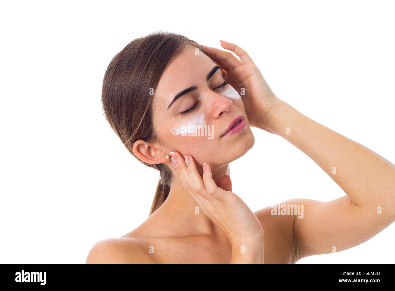Young woman using cream Stock Photo - Alamy