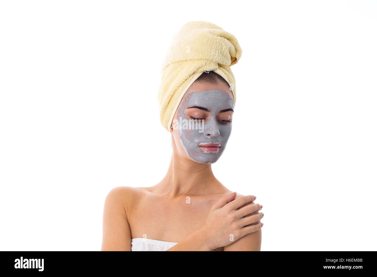 Woman with towel on her head and cosmetic mask on her face Stock Photo ...